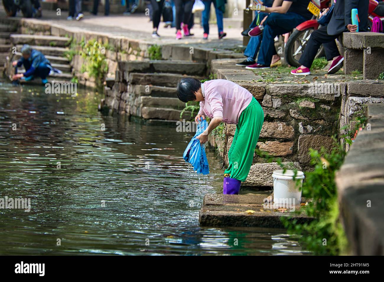 Woman washing the laundry in a water canal in Suzhou, China Stock Photo ...