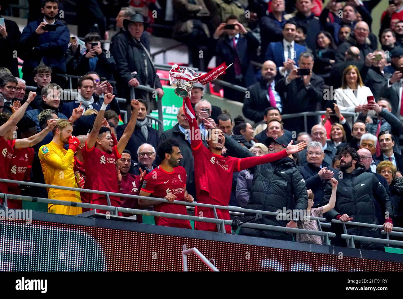 Liverpool's Virgil van Dijk lifts the trophy as he celebrates with his ...