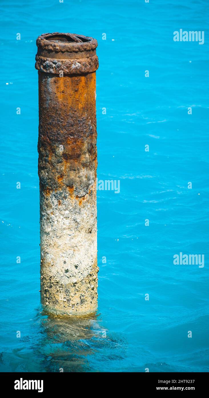 Vertical closeup of the rusty pipe in the water Stock Photo - Alamy