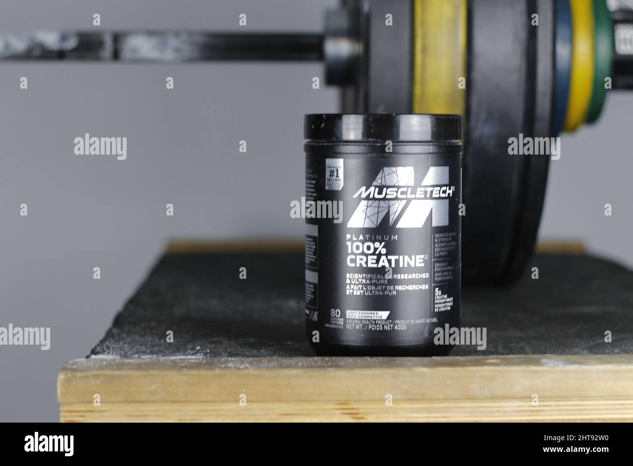 Creatine monohydrate supplement in front of the weights Stock Photo - Alamy