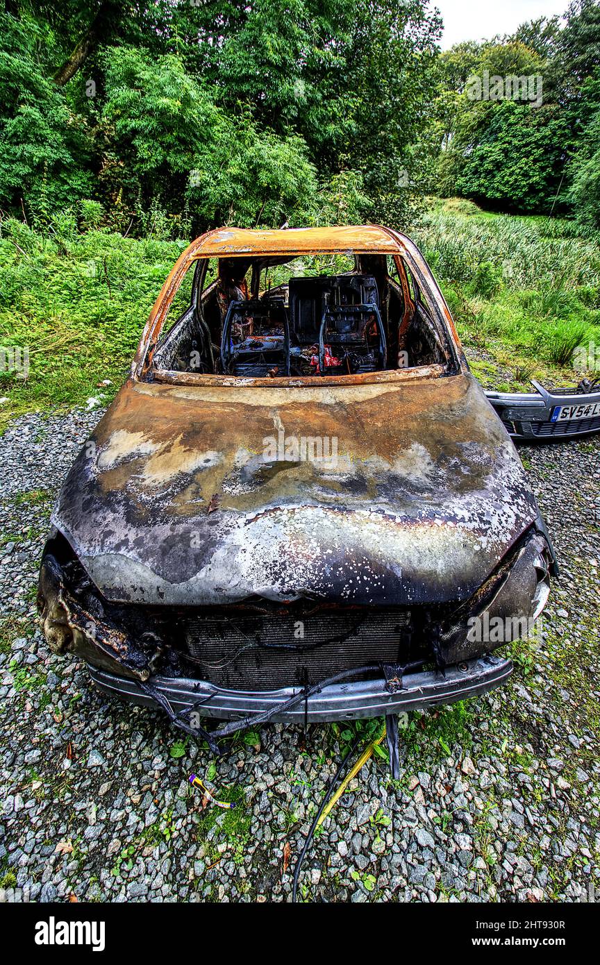 HDR bruned car lost place abandon Stock Photo - Alamy