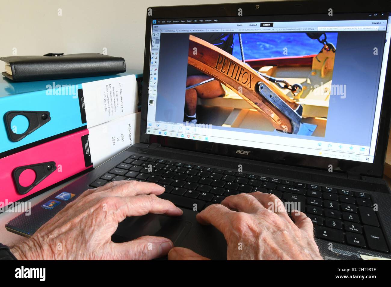 Old Hands at a computer keyboard finding pictures to trigger pleasant ...