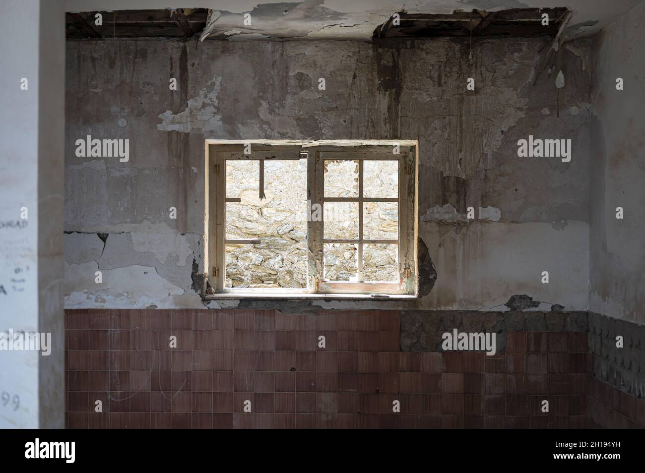 Window with a broken glass in an old abandoned house seen from inside ...