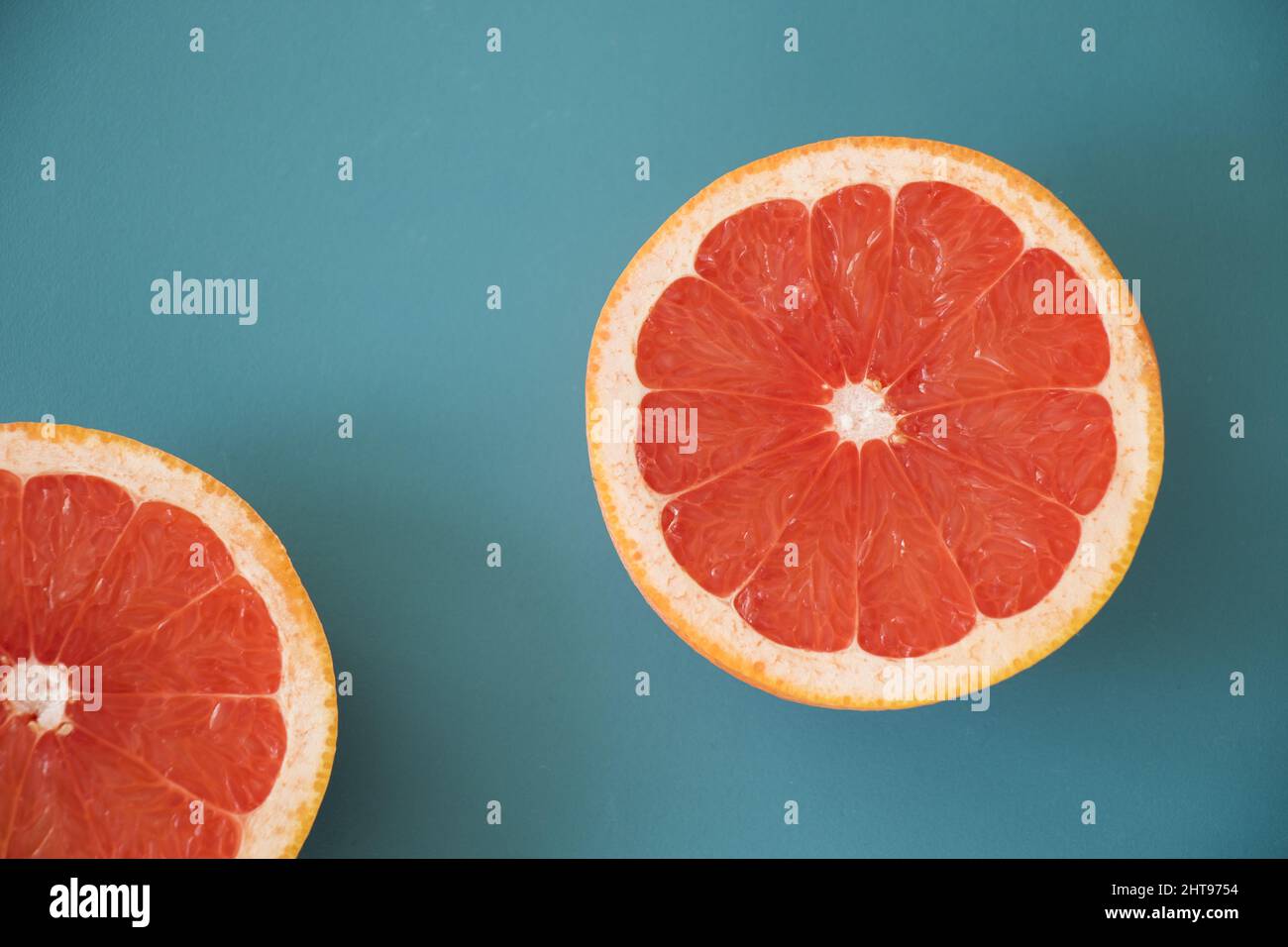 Closeup of a sliced grapefruit on the blue background, cut grapefruit ...