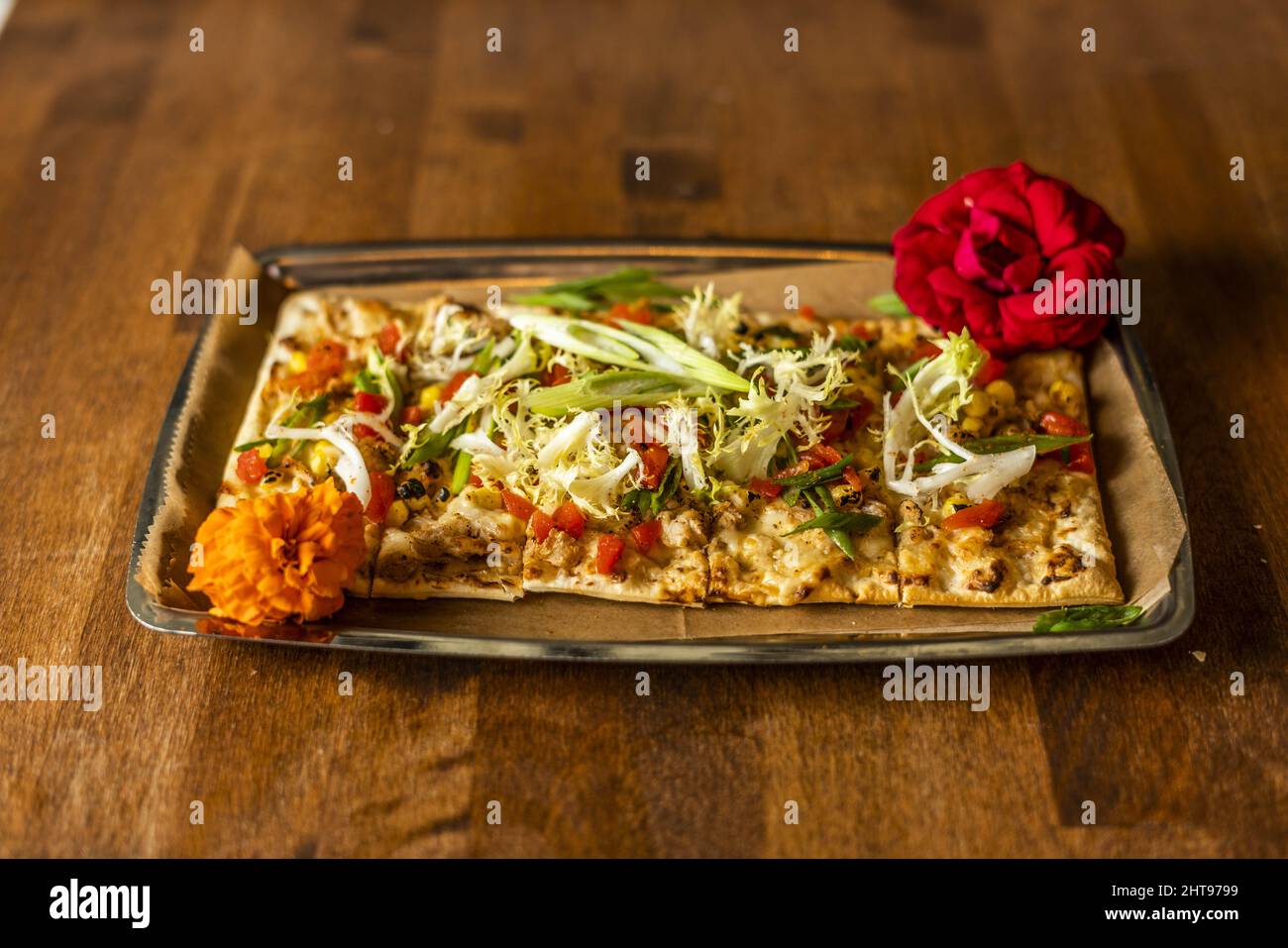 Closeup shot of a rectangular pizza at a high end craft cocktail bar ...