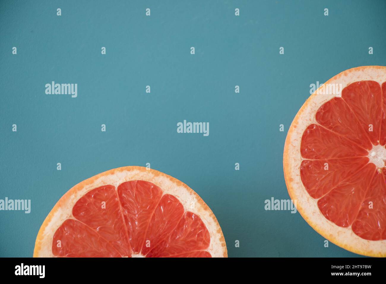 Closeup of a sliced grapefruit on the blue background, cut grapefruit ...