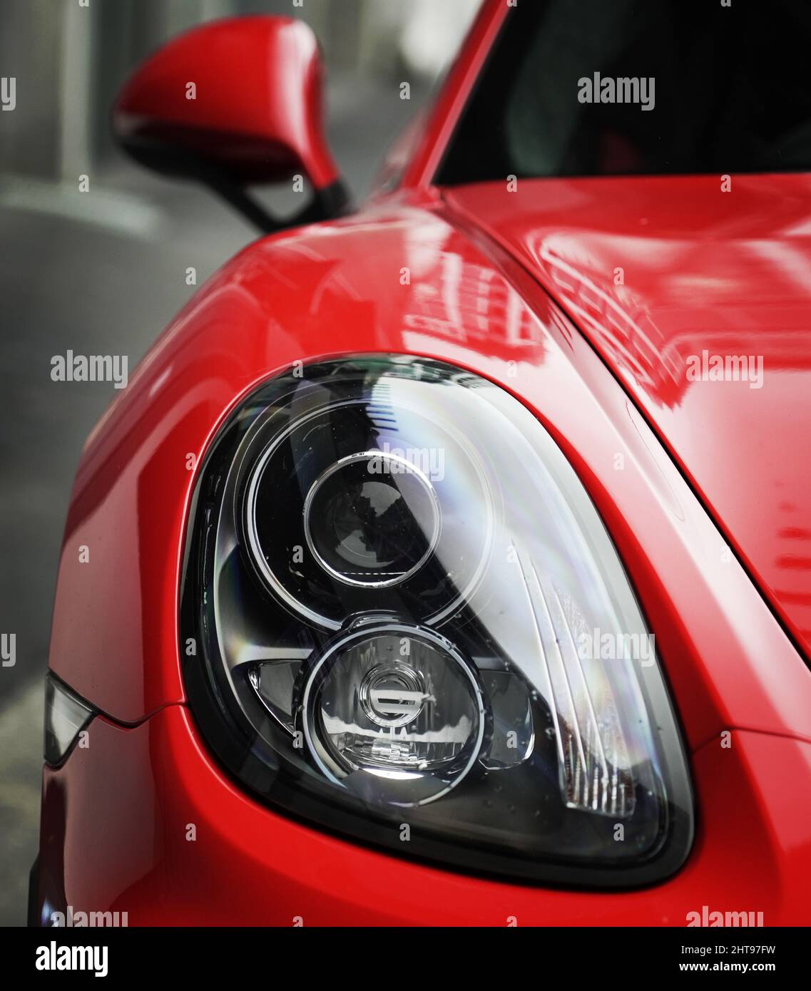 Closeup of the headlight of a modern luxury red car Stock Photo - Alamy