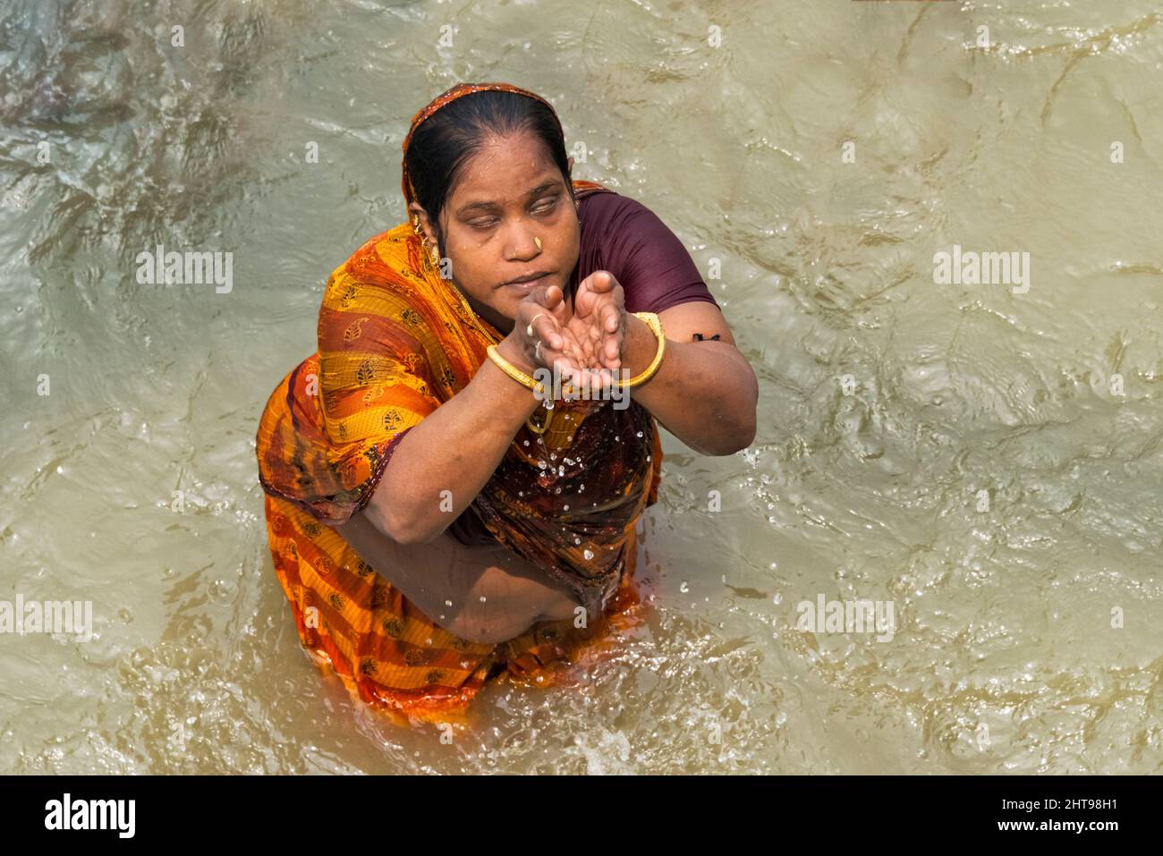 Woman taking a holy dip in Ganges River, Kolkata, West Bengal, India ...