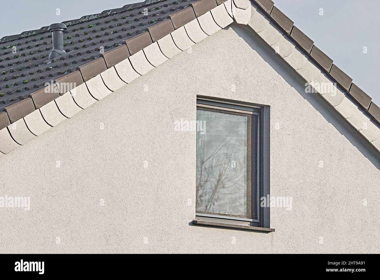 Exterior of a house with a window and gray metal tile rooftop Stock ...