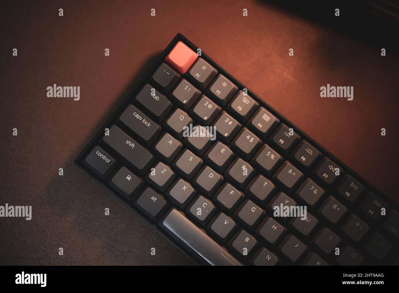 Closeup of A bluetooth wireless keyboard on a dark brown desk Stock ...