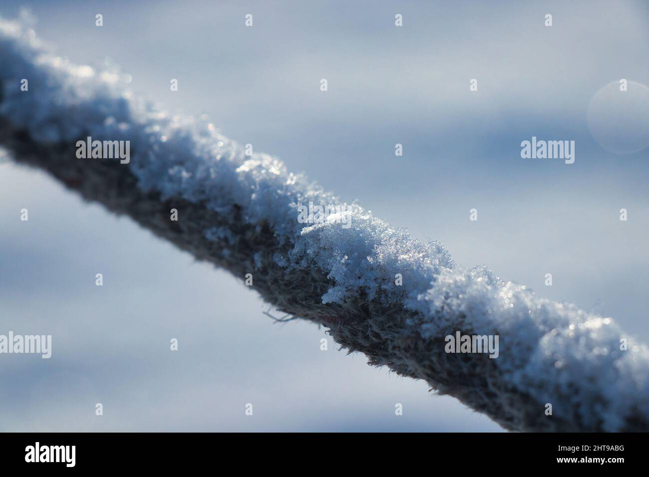 Closeup of a weathered worn out rope covered in shiny snow Stock Photo ...