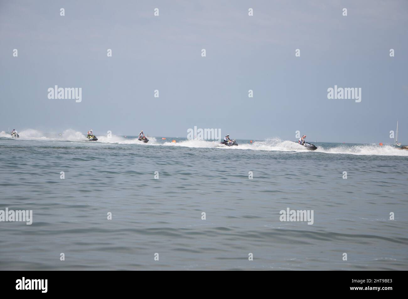 Group of people having fun and riding jet skis on a beach Stock Photo ...