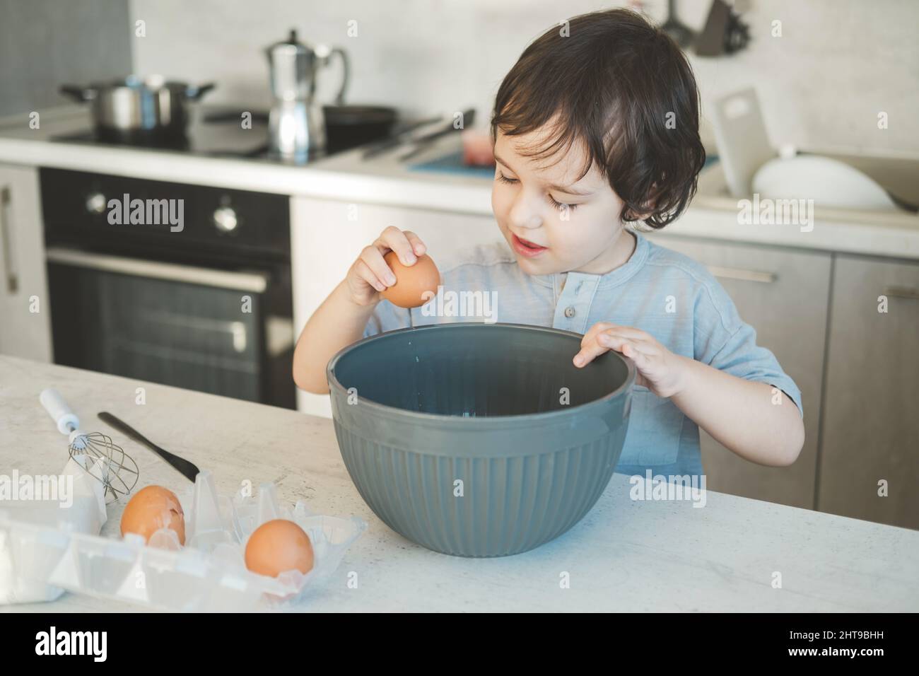 A little boy is cooking in the kitchen Stock Photo - Alamy