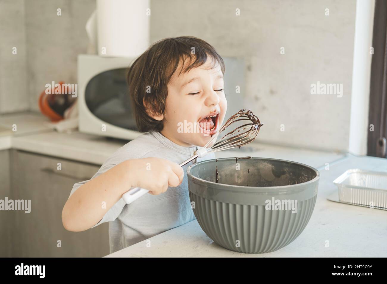 A little boy is cooking in the kitchen Stock Photo - Alamy