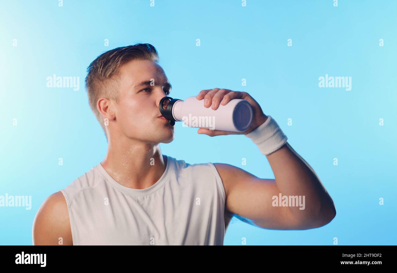 Its important to stay hydrated. Studio shot of a handsome young man ...