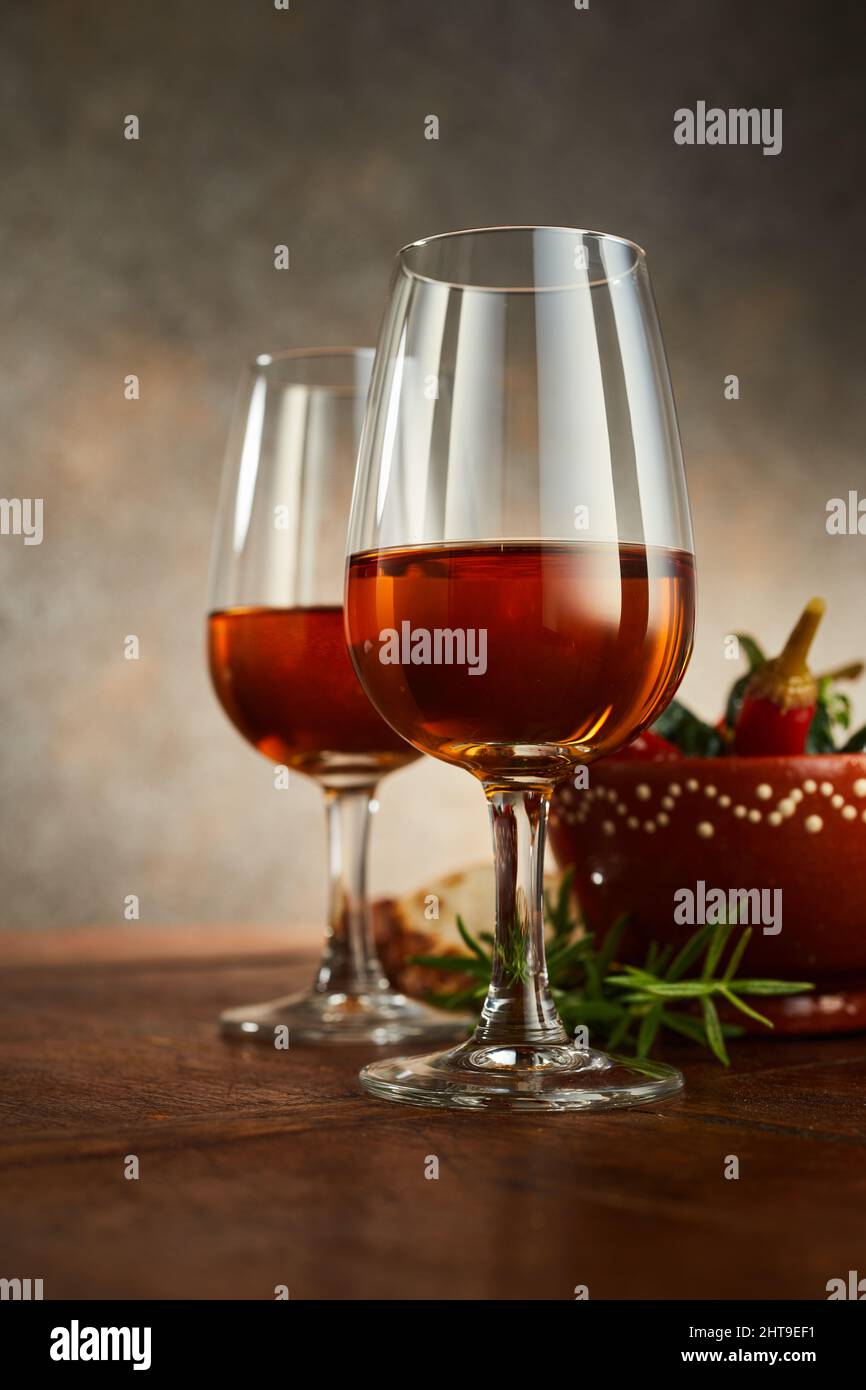 Shiny wine glasses with sherry drink laced on a wooden counter Stock ...