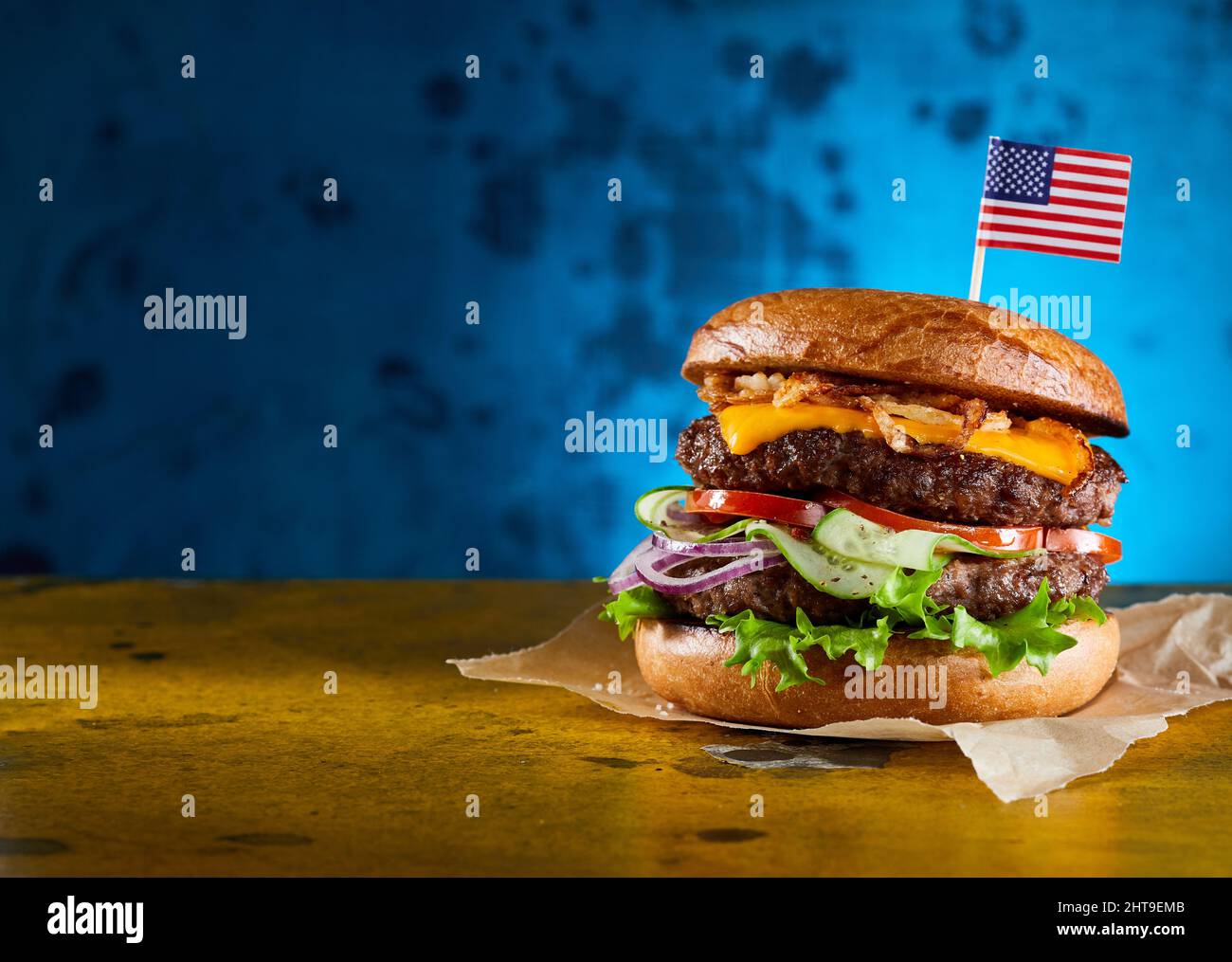 Delicious double burger with beef cutlets and fresh vegetables served ...