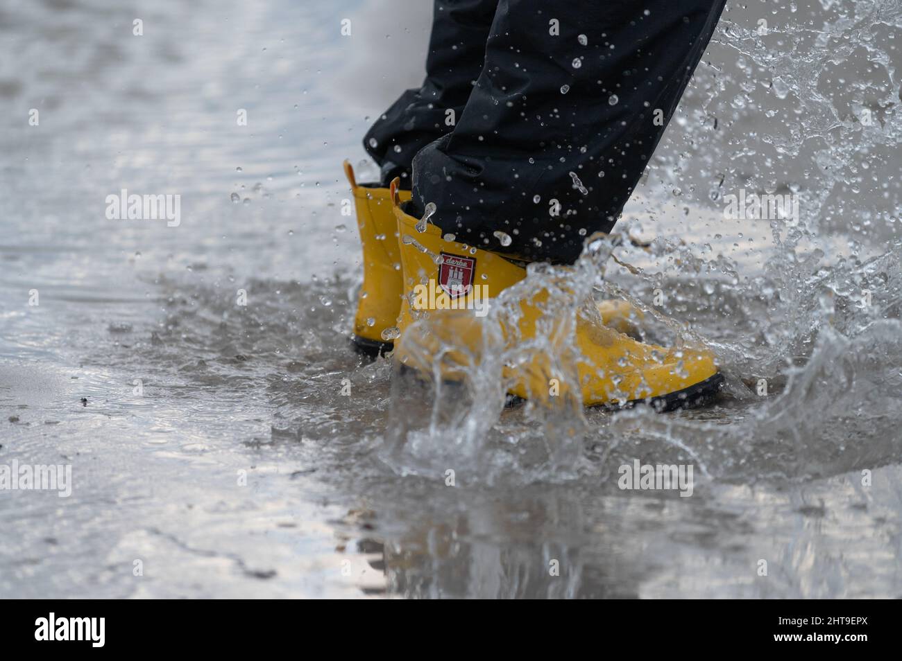 Man jumps into a puddle, Hamburg, Germany Stock Photo - Alamy
