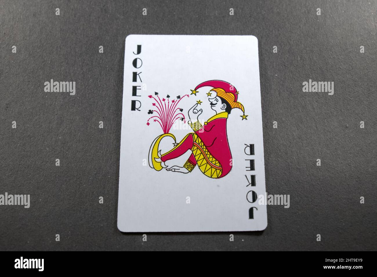 Joker playing card isolated on black background Stock Photo - Alamy