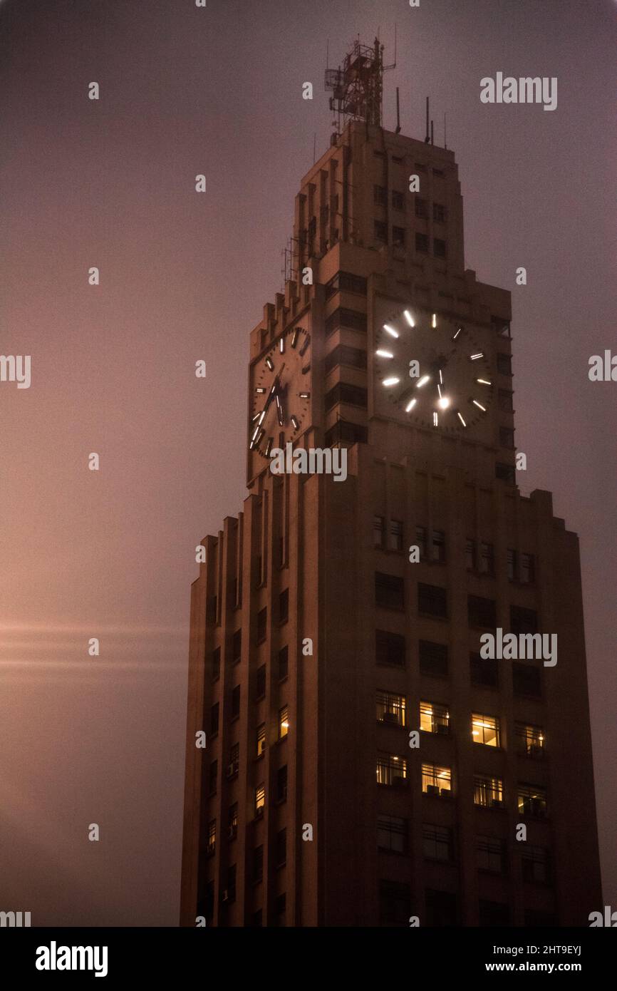 Vertical low angle of a big tower clock at sunset Stock Photo - Alamy