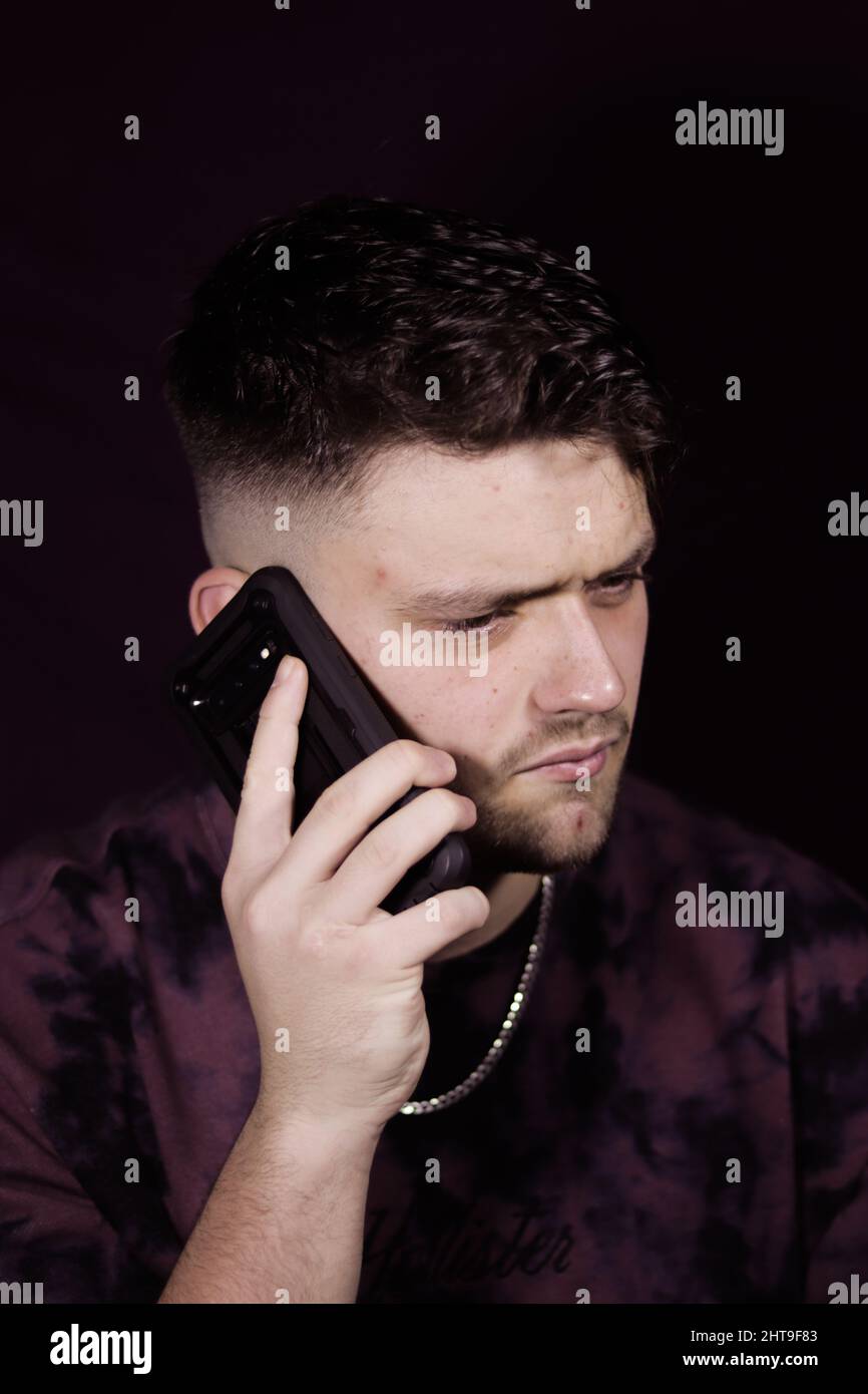Vertical portrait of a caucasian man talking on the phone with an ...