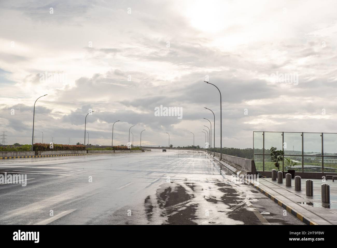Wide empty road with street lights on both sides Stock Photo - Alamy