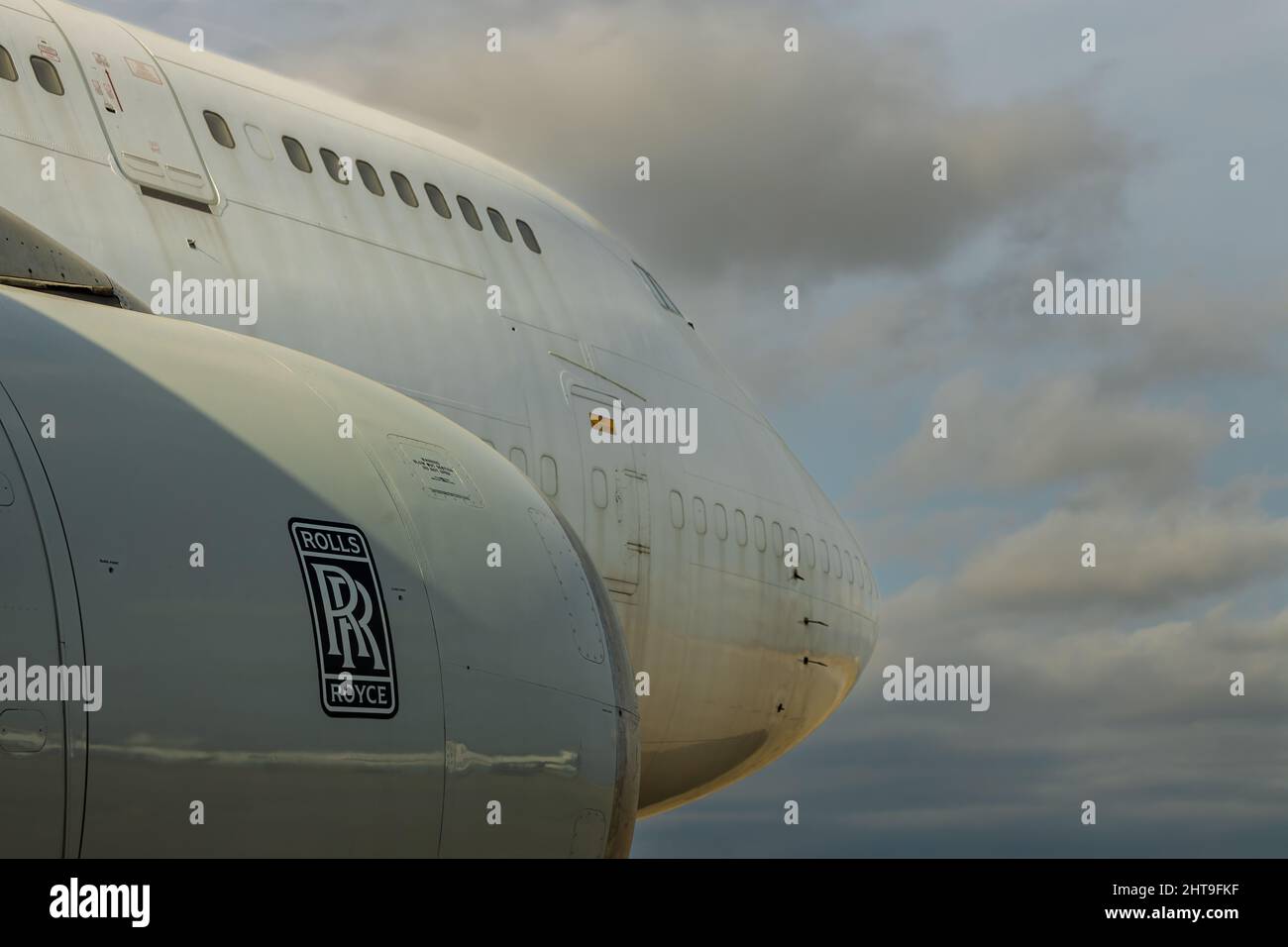 Side shot of a boeing 747 with rolls royce engines against a cloudy sky ...