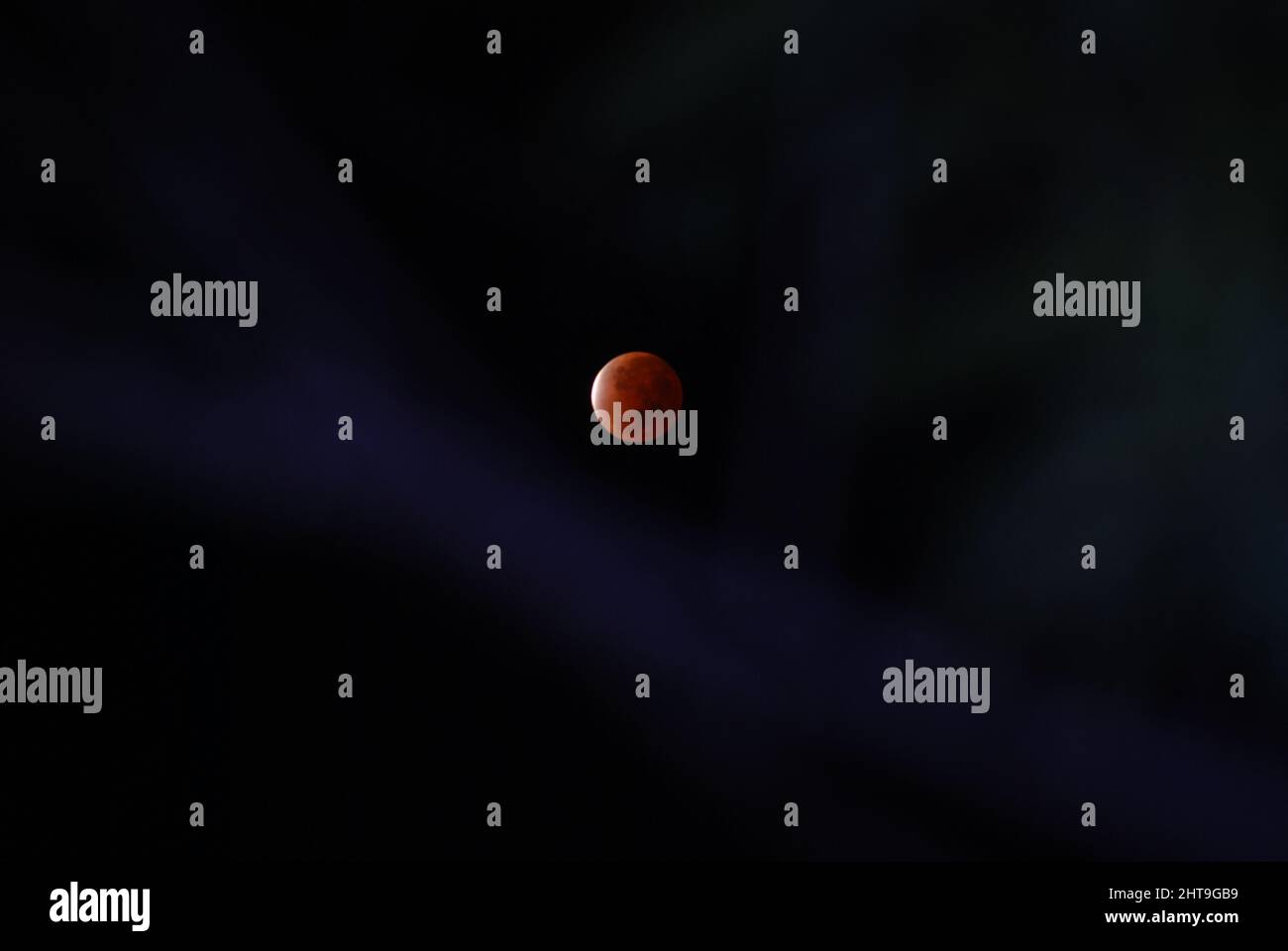 Beautiful view of a red moon, Lunar eclipse in the wavy dark sky at ...