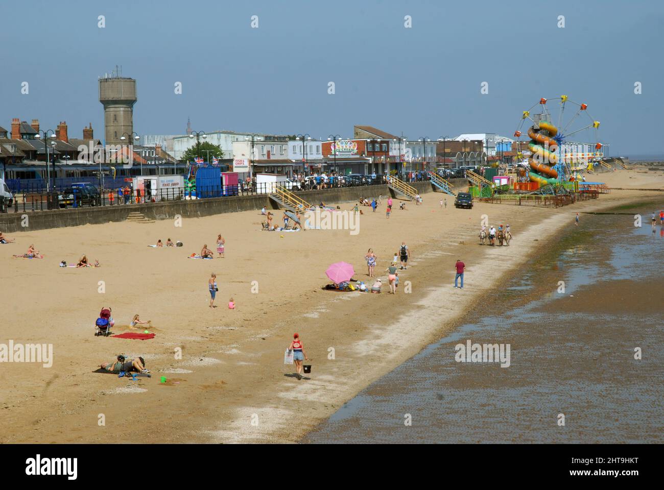 People enjoying the summer sunshine on a sandy beach in the picturesque ...