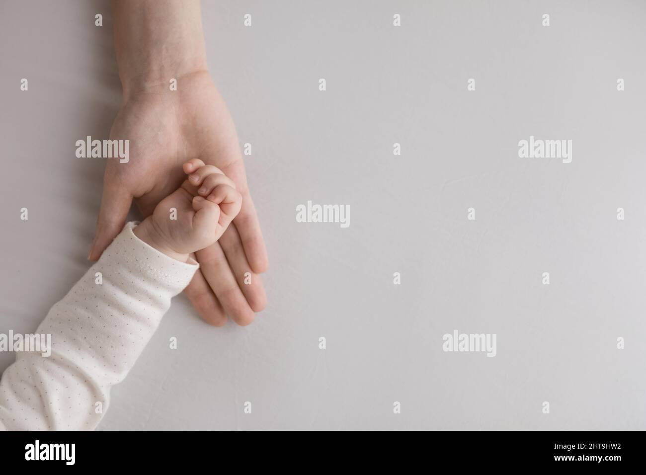 Hand of sweet few month baby resting in mothers palm Stock Photo - Alamy