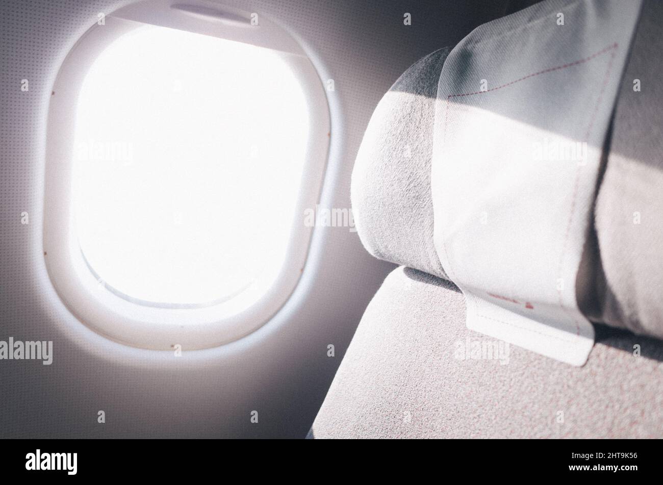 Photo of sunlight peering through a plane window on a seat Stock Photo ...