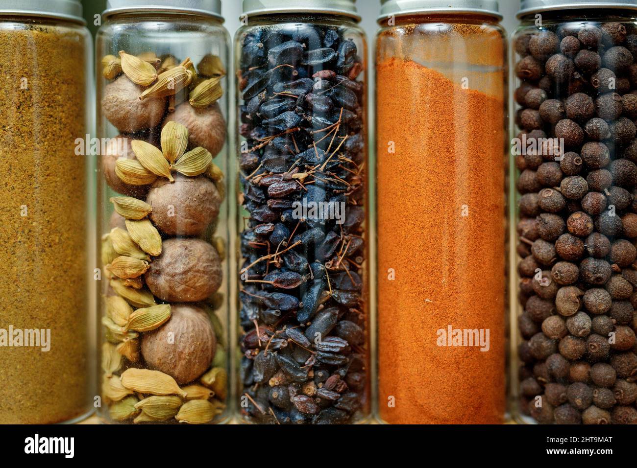 Different spices close-up in glass flasks for spices Stock Photo - Alamy