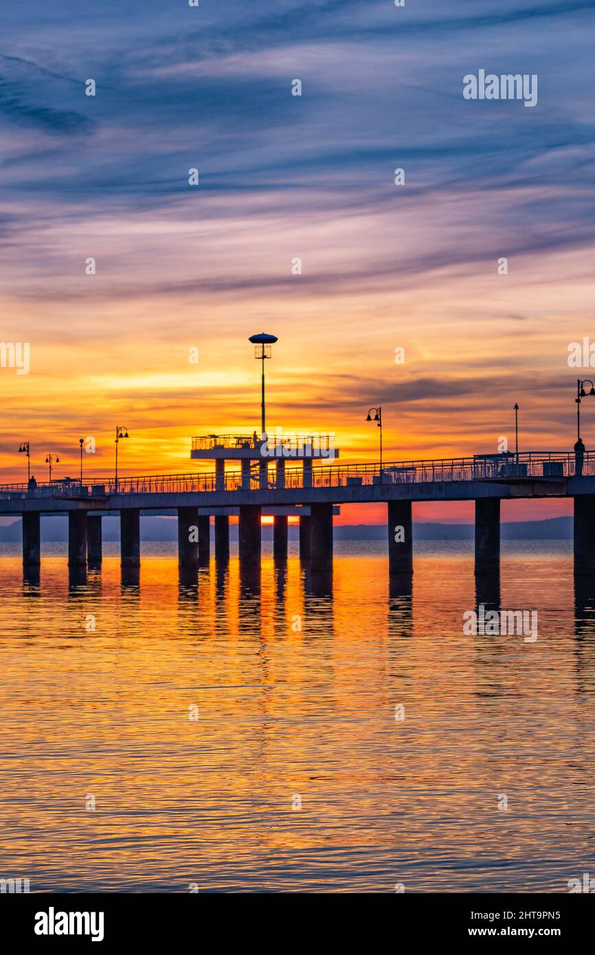 Stunning view of the famous Burgas sea bridge against a dramatic orange ...