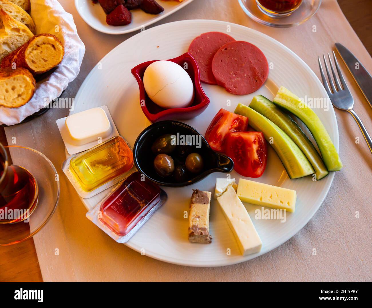 Turkish breakfast: egg, vegetables, cheeses, olives and ham. Halal ...