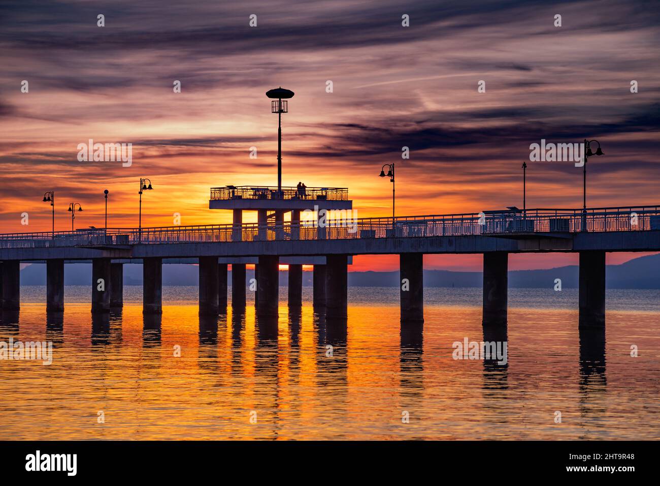 Stunning view of the famous Burgas sea bridge against a dramatic orange ...