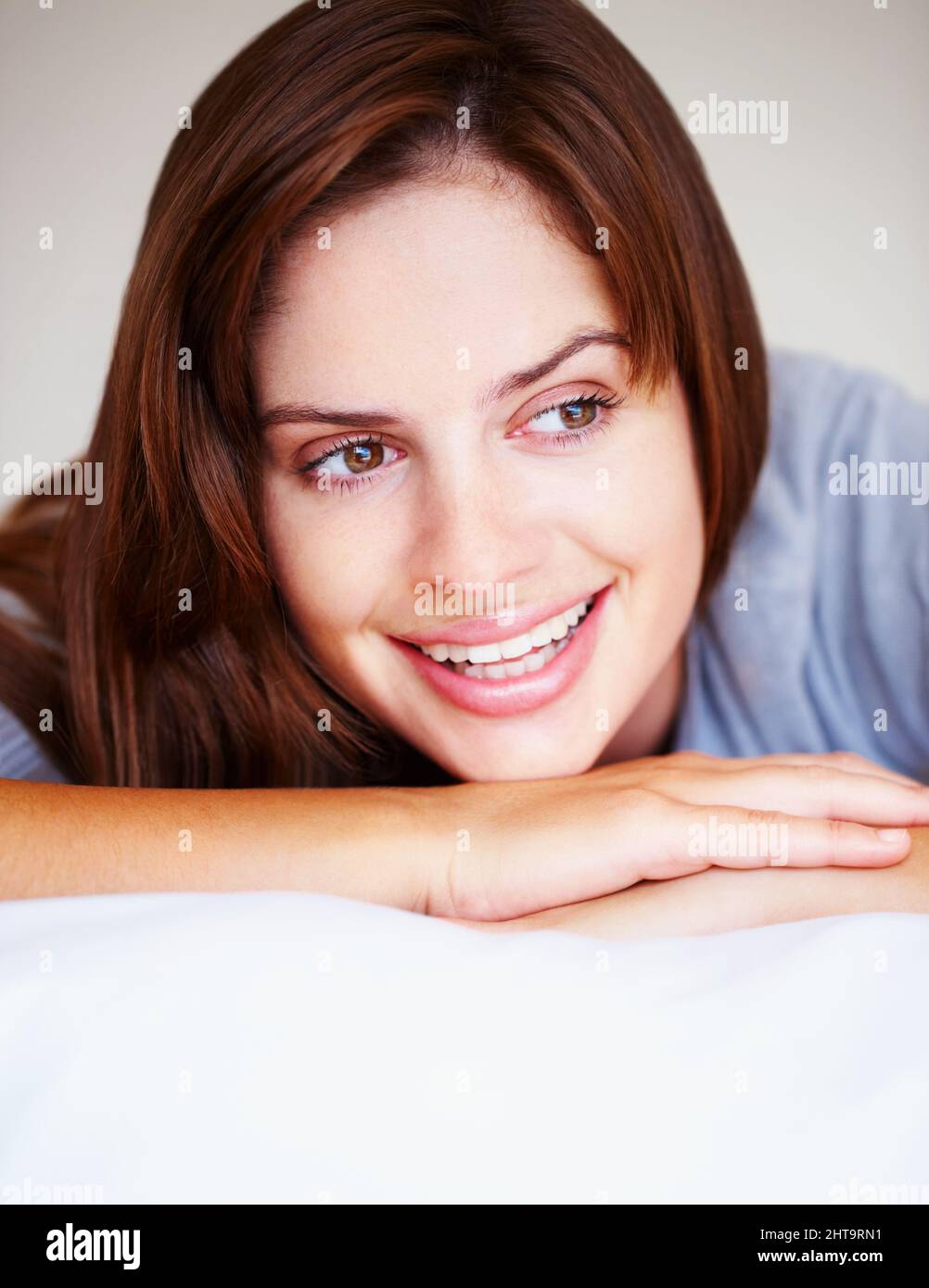 Smiling Cute Female Brunette Lying On Bed Closeup Portrait Of A Cute Smiling Female Brunette