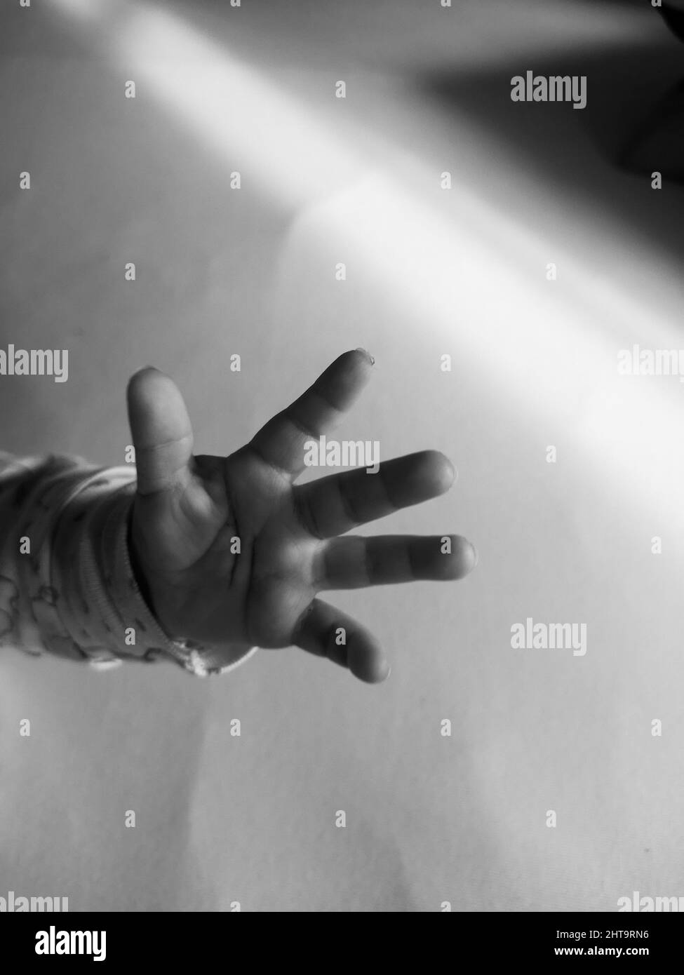 Grayscale of a small baby hand Stock Photo - Alamy