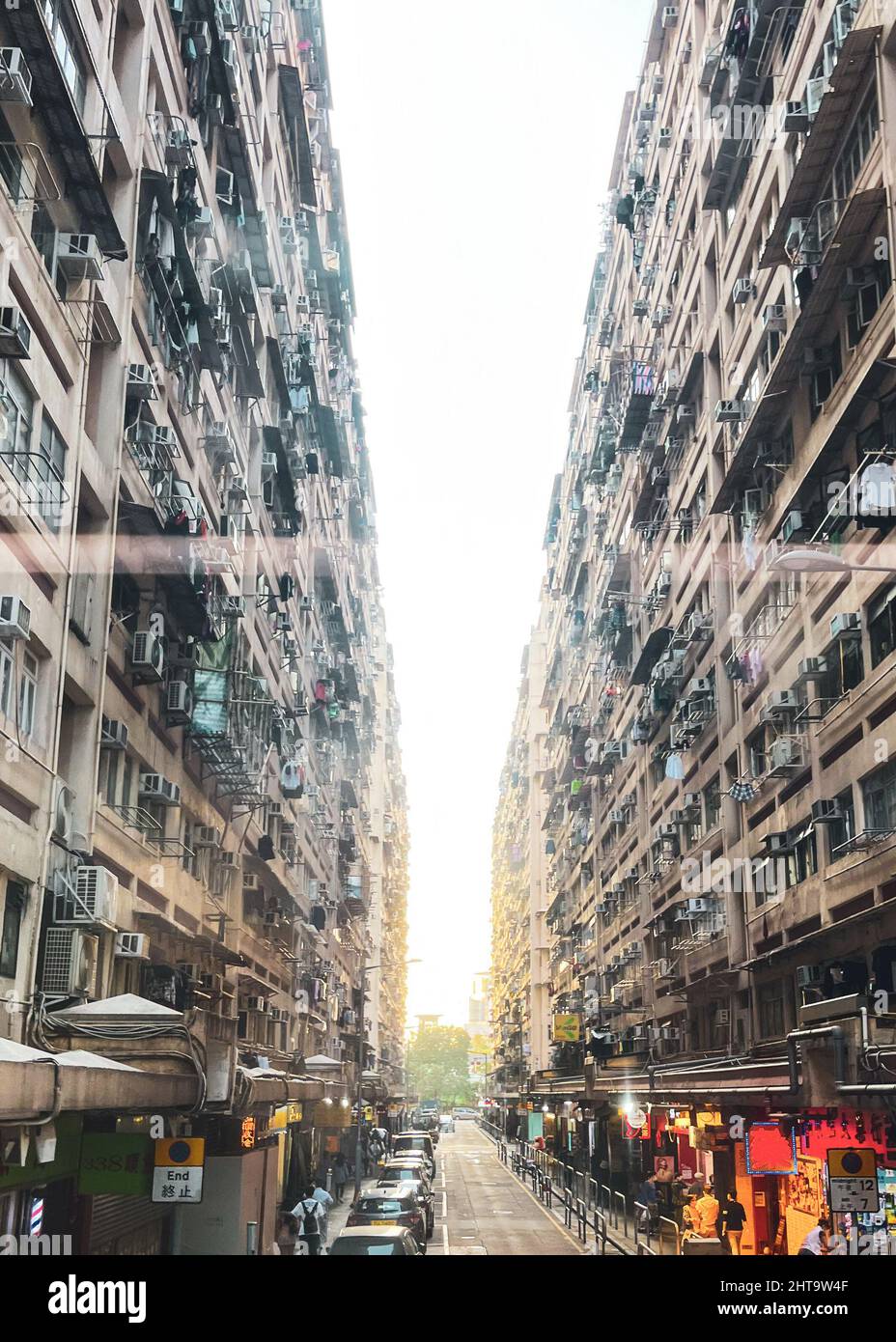 Beautiful shot of a street with cars between buildings and sunlight on ...
