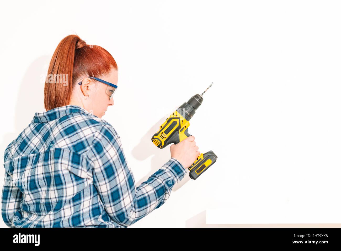 Woman using electric drill hi-res stock photography and images - Alamy