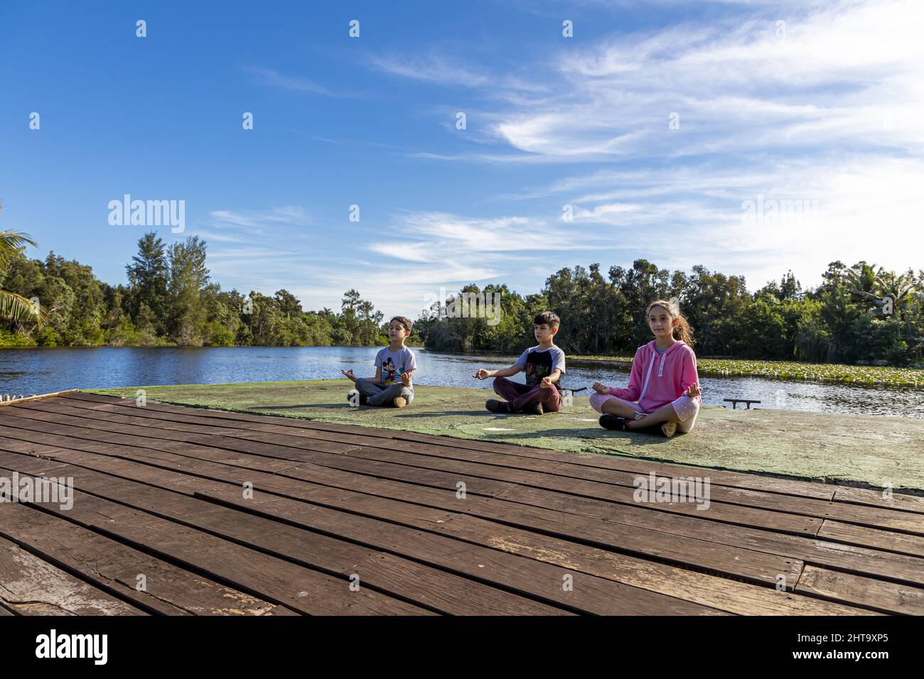 Group of young tourists doing yoga in Tour Laguna del Tesoro in Guama ...