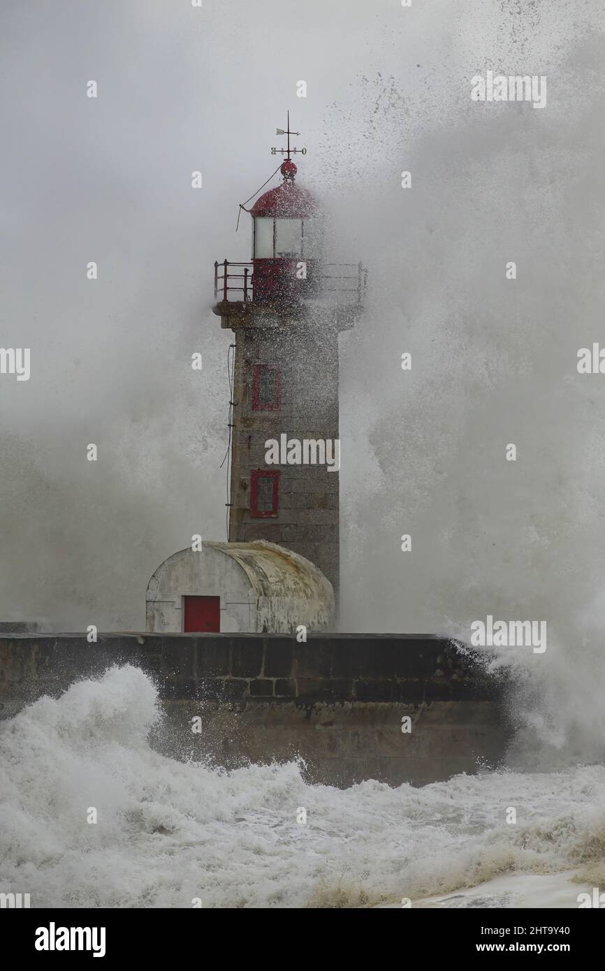 Dramatic scenery of strong waves splashing lighthouse near the ...