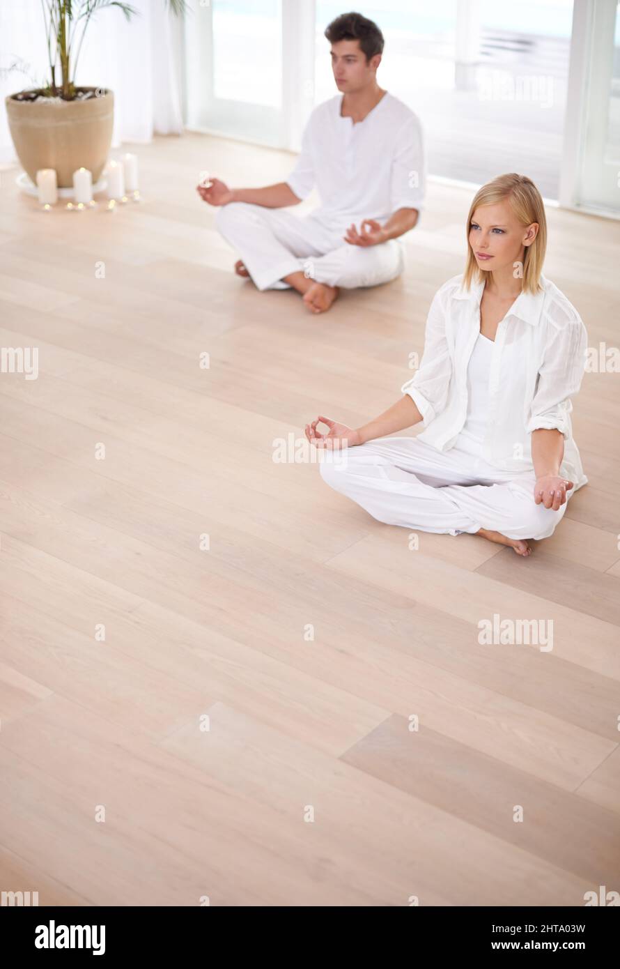 Finding inner peace together. Two people sitting cross legged and doing ...