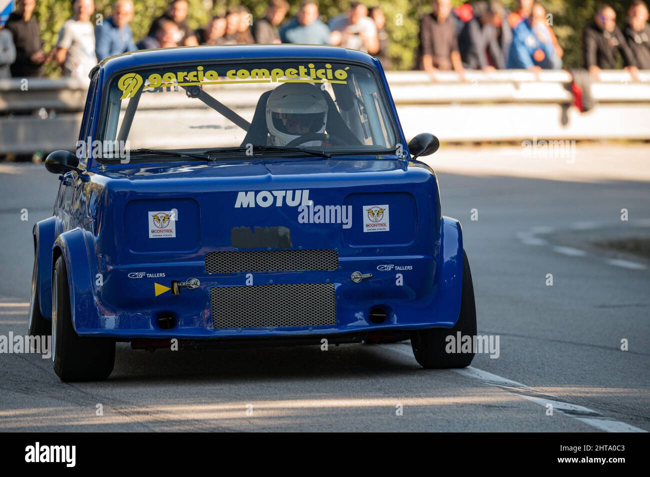 Rally car driving at the competition in the background of fans Stock ...