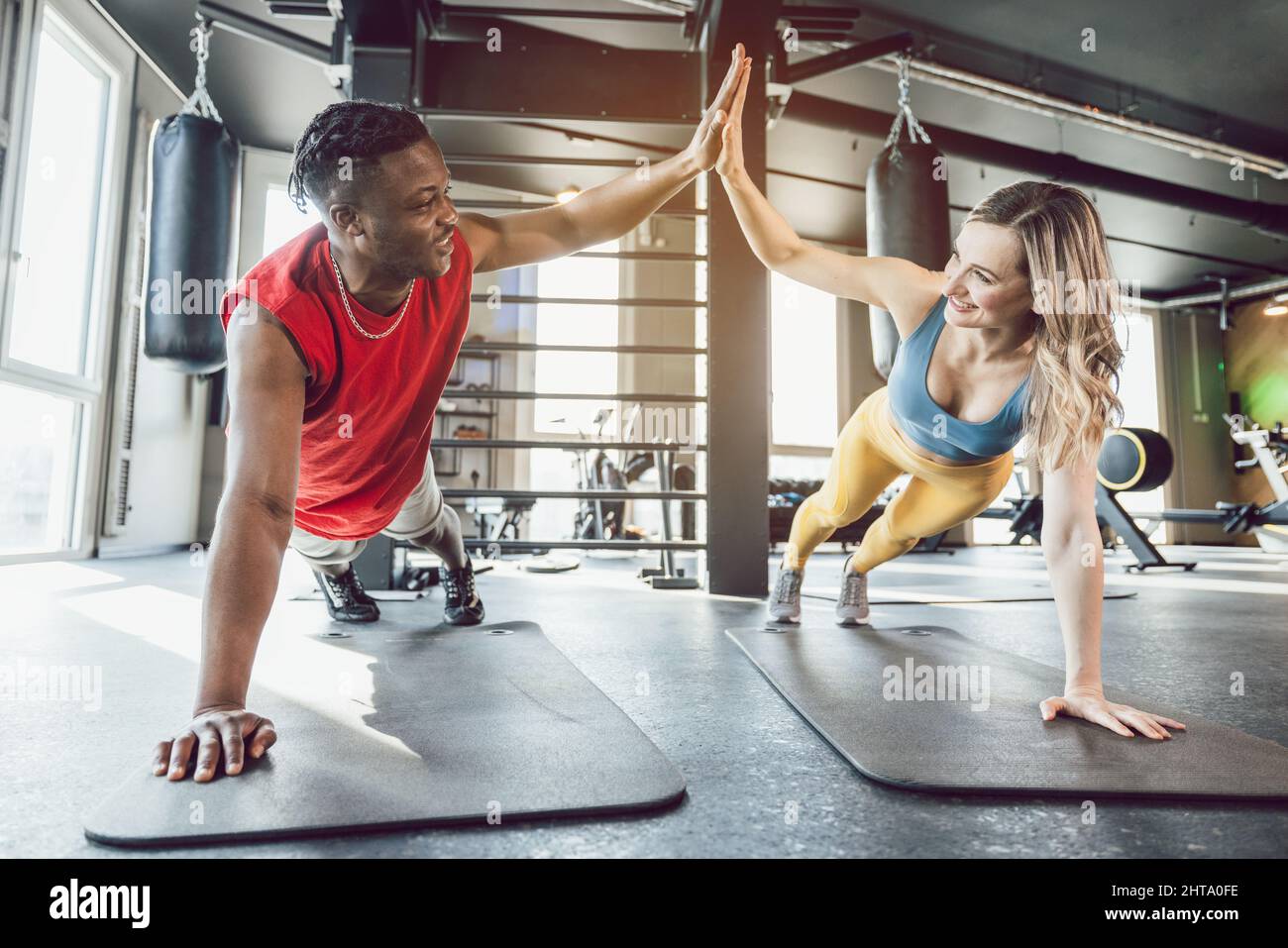 Fit man and woman in gym exercising abs Stock Photo - Alamy