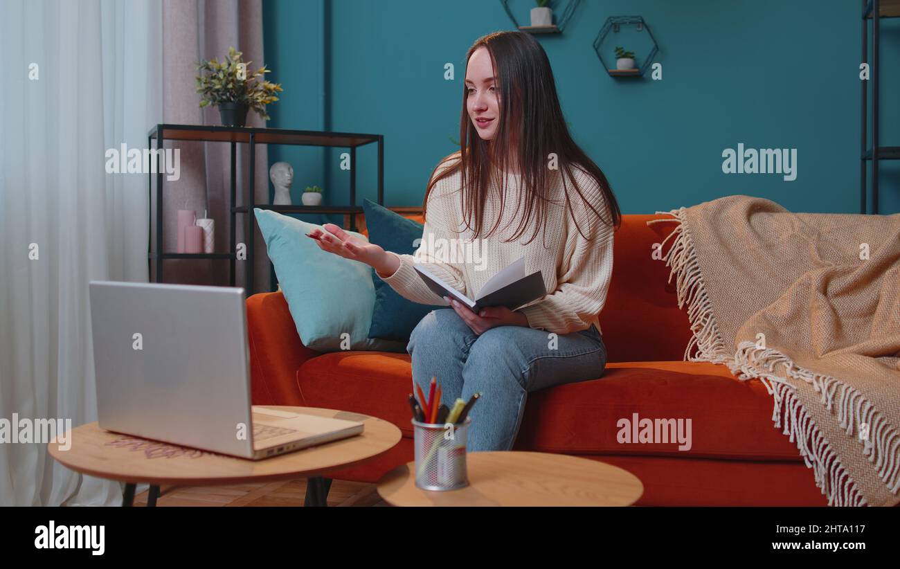 Adult girl student study at home on laptop computer making conference ...