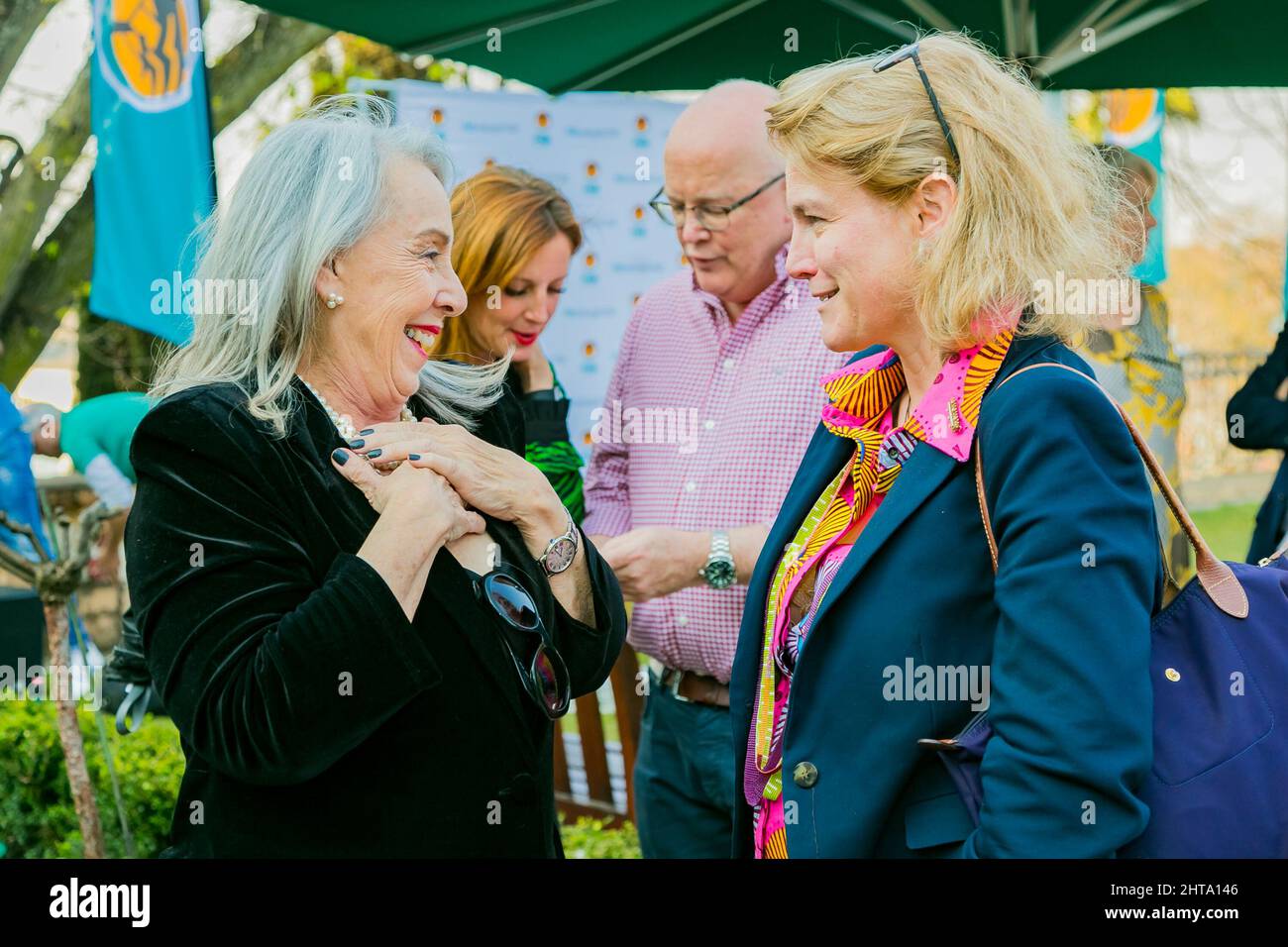 Number of VIP guests mingling at an outdoor social event in ...