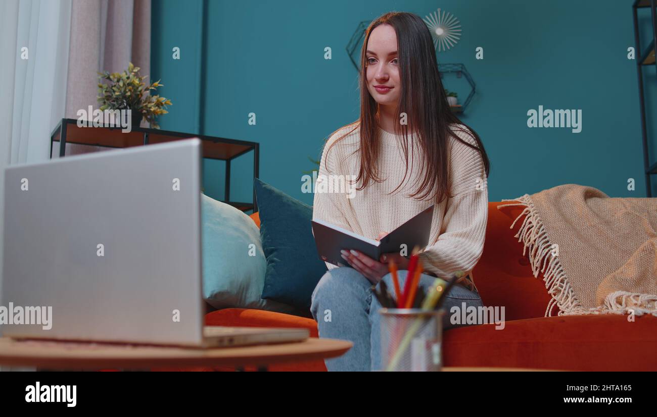 Adult girl student study at home on laptop computer making conference ...