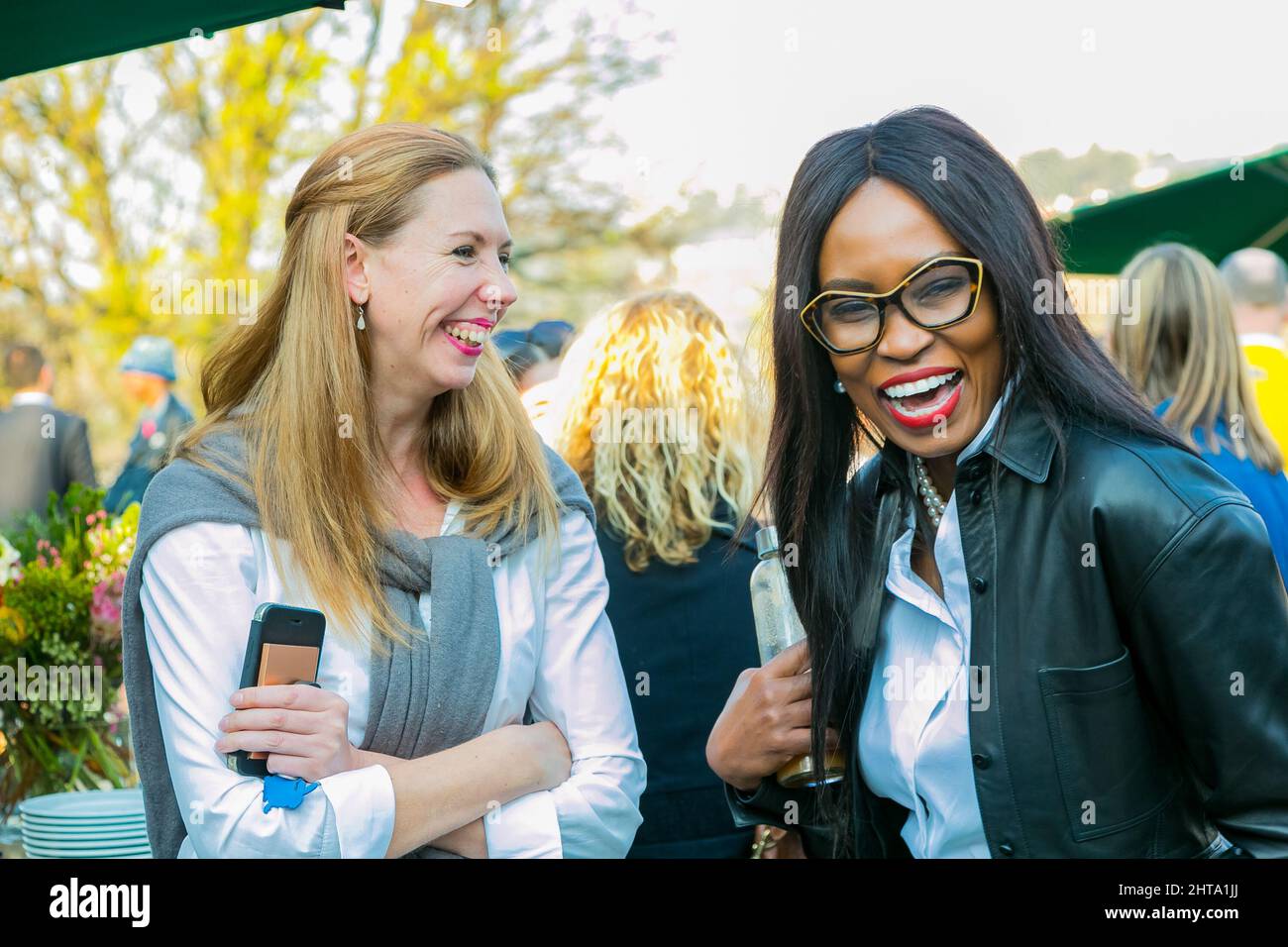 Number of VIP guests mingling at an outdoor social event in ...