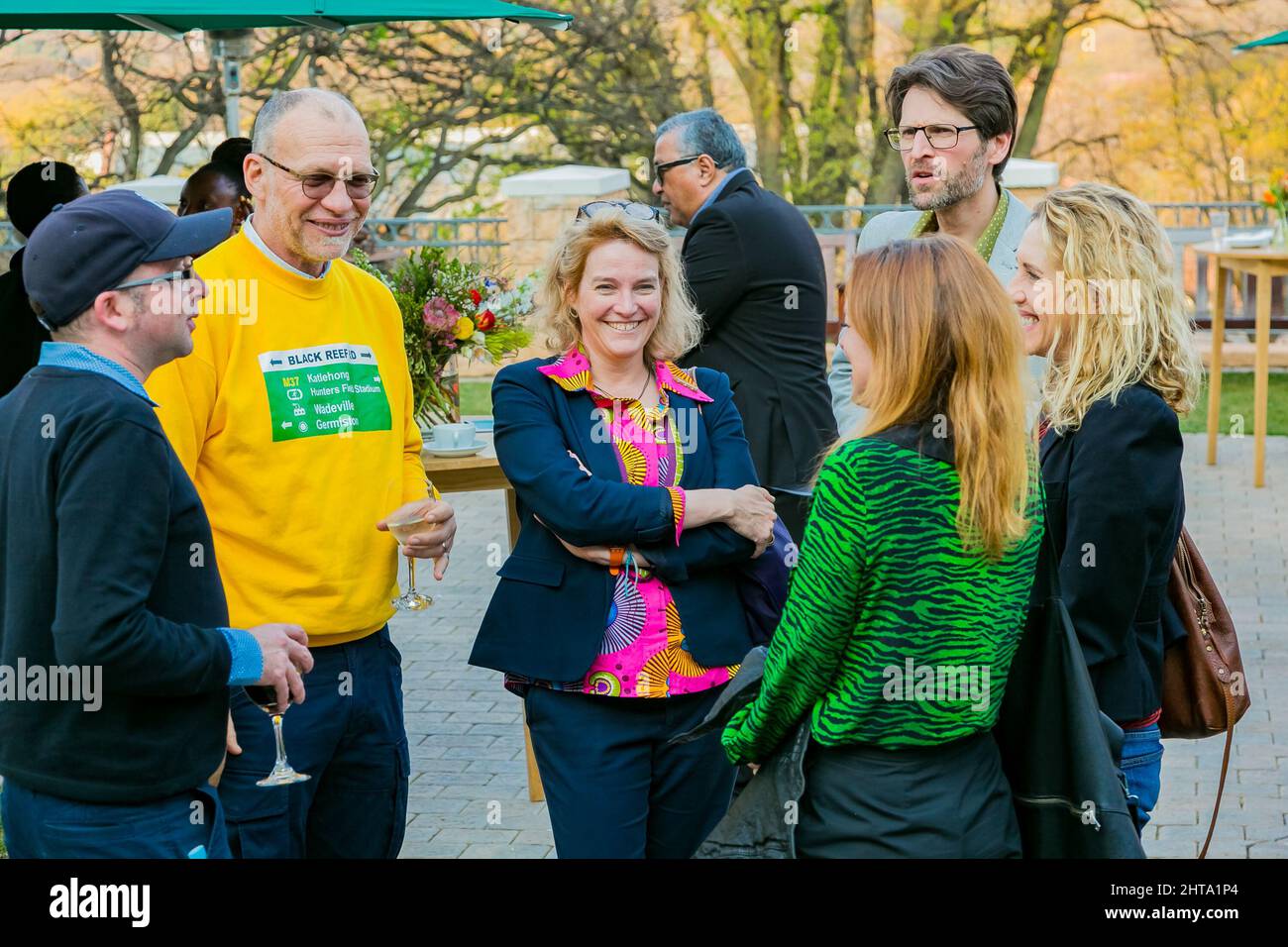 Number of VIP guests mingling at an outdoor social event in ...
