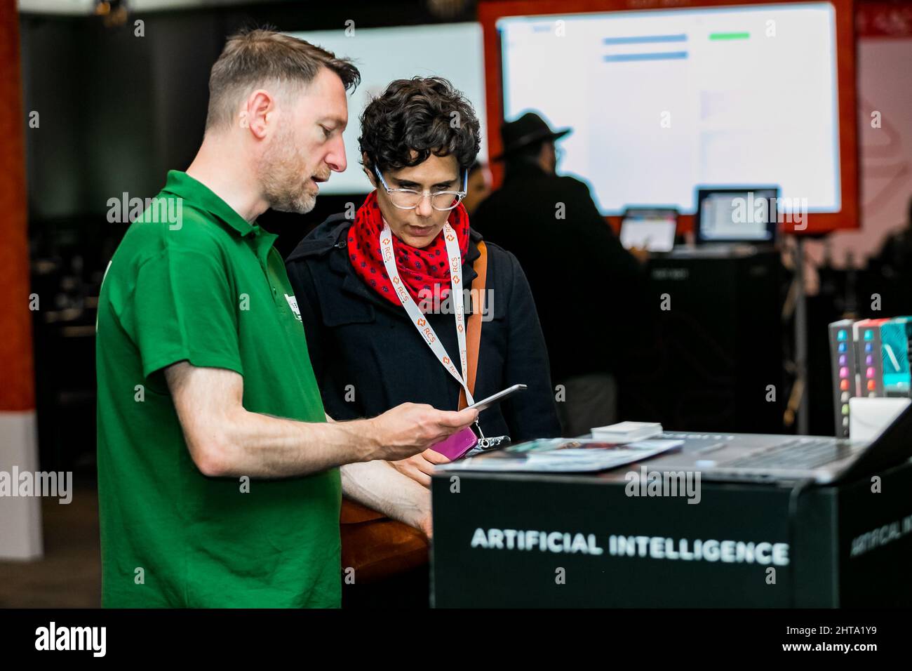 Vendors demonstrating a product service at a retail industry conference ...